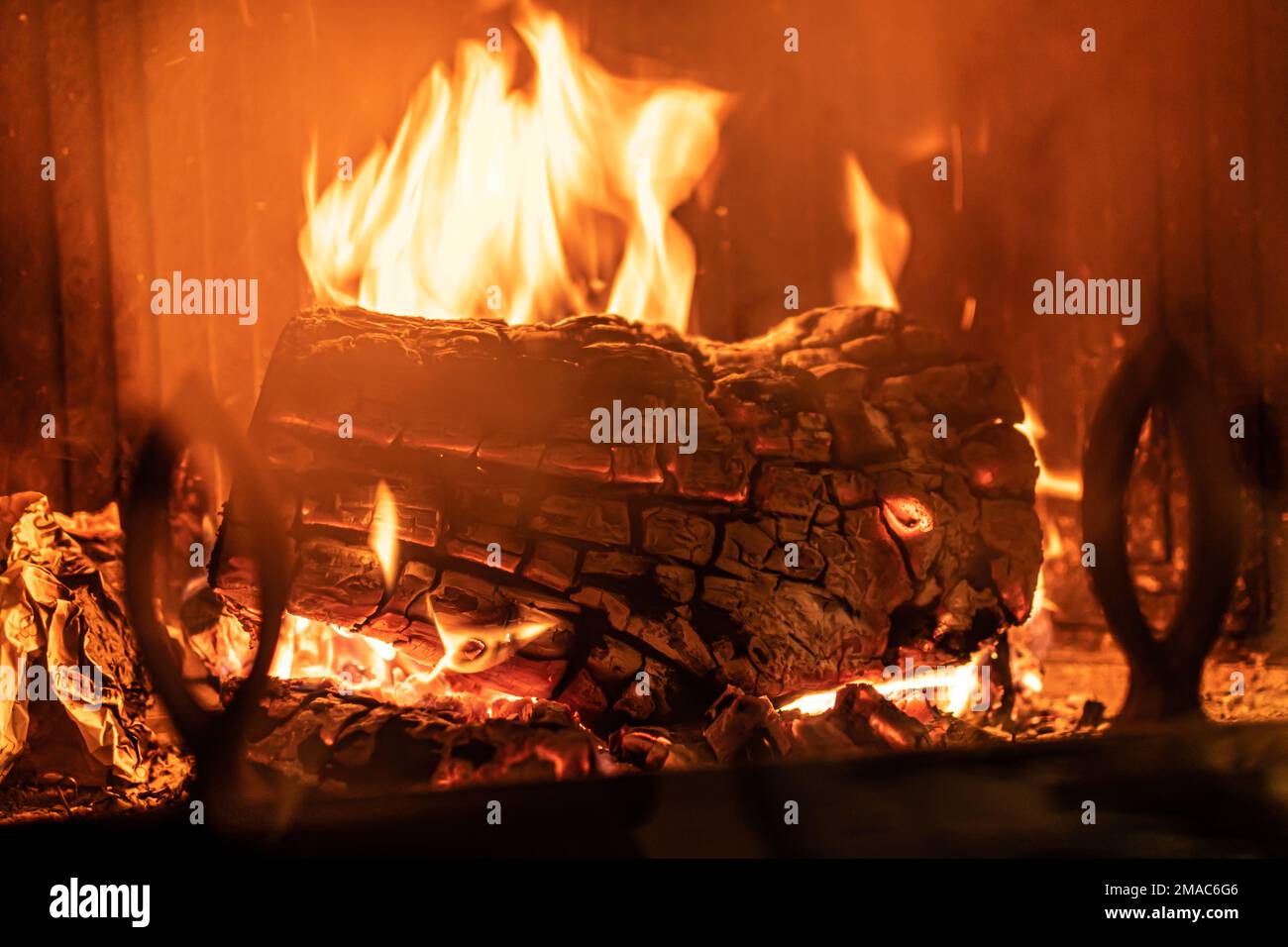 Log of wood burning in a fireplace inside a house, hearth Stock Photo ...
