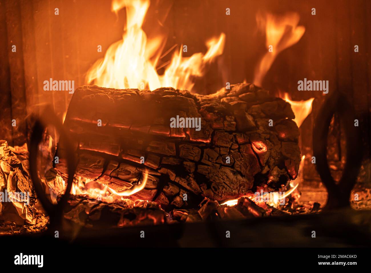 Log of wood burning in a fireplace inside a house, hearth Stock Photo ...
