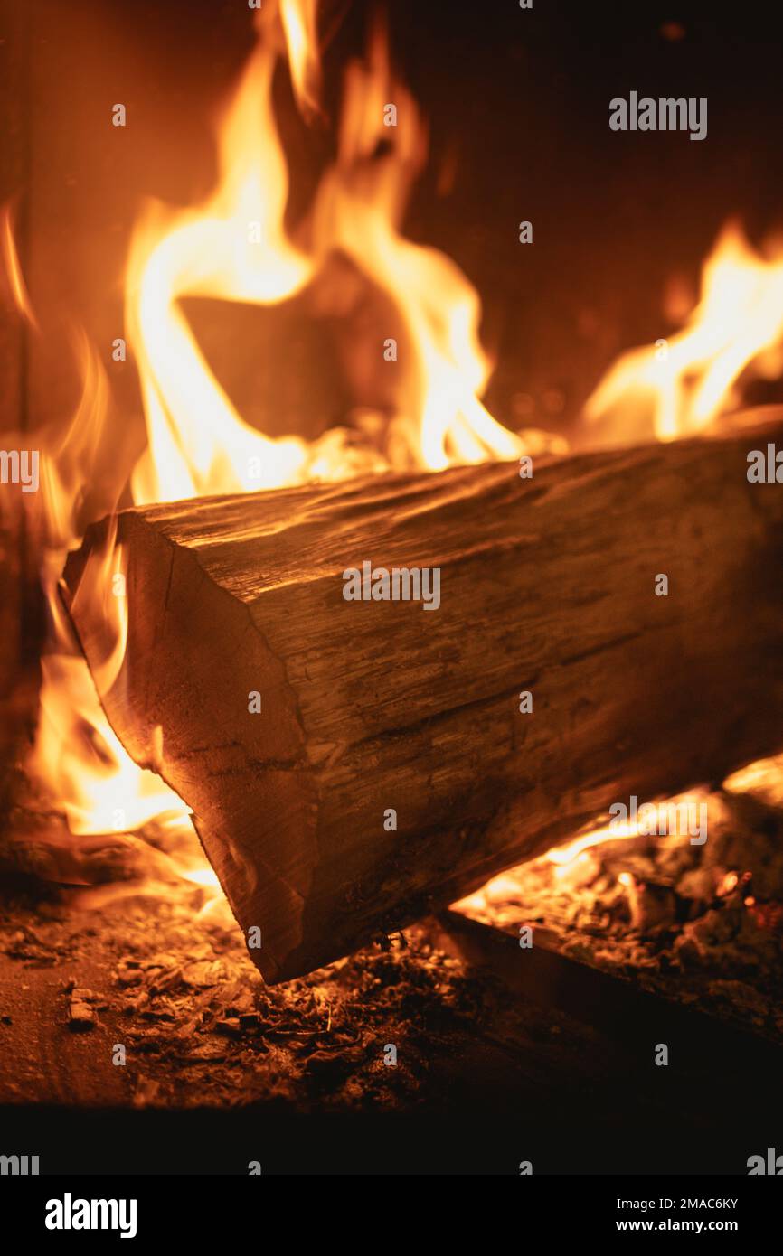 Log of wood burning in a fireplace inside a house, hearth Stock Photo ...