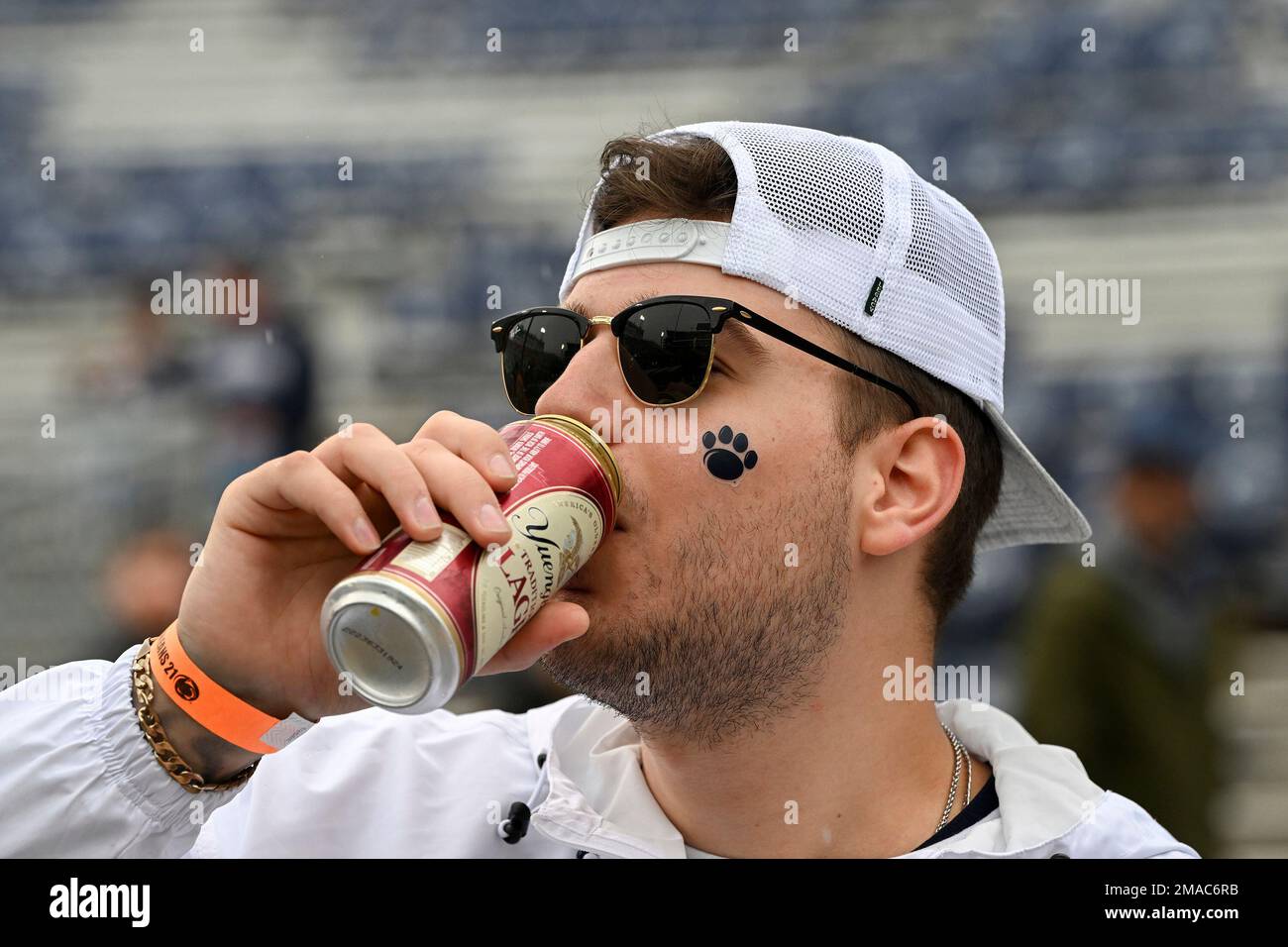 Penn State fan Mason Picarelli drinks a beer n the stands at Beaver ...