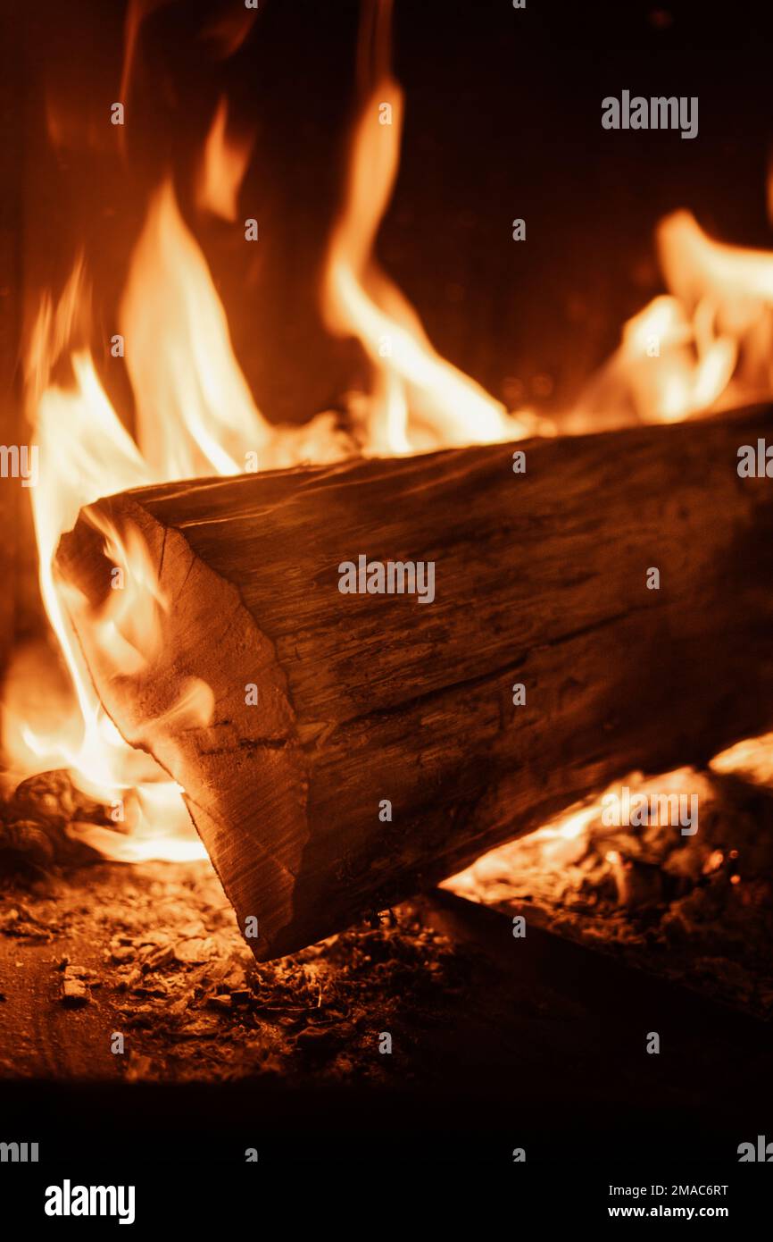 Log of wood burning in a fireplace inside a house, hearth Stock Photo ...