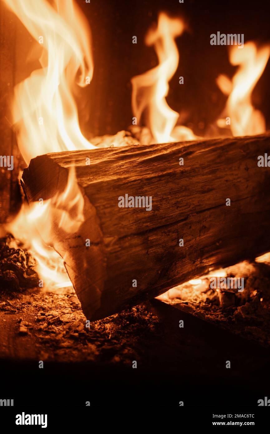Log of wood burning in a fireplace inside a house, hearth Stock Photo ...