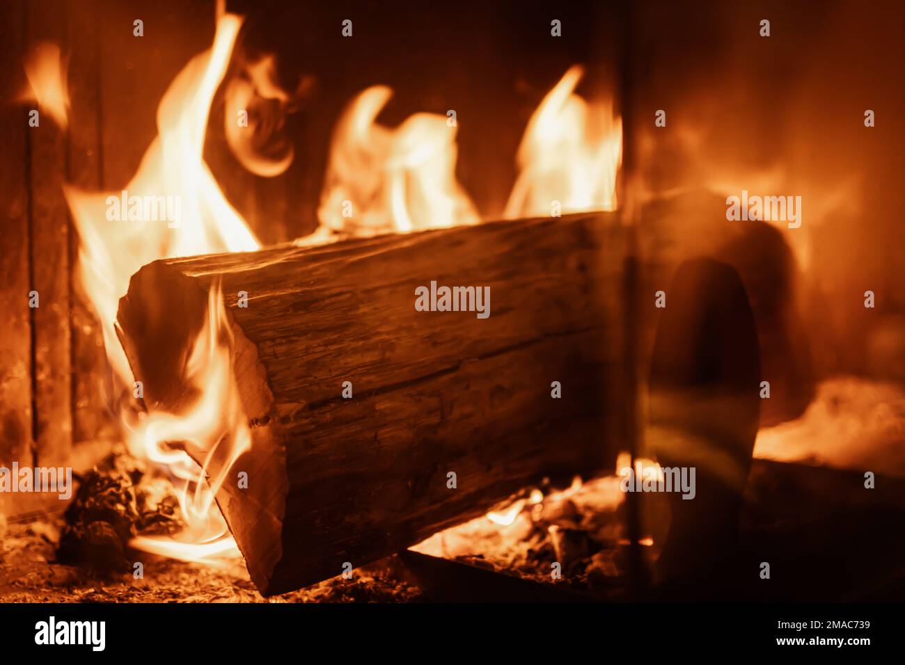 Log of wood burning in a fireplace inside a house, hearth Stock Photo ...
