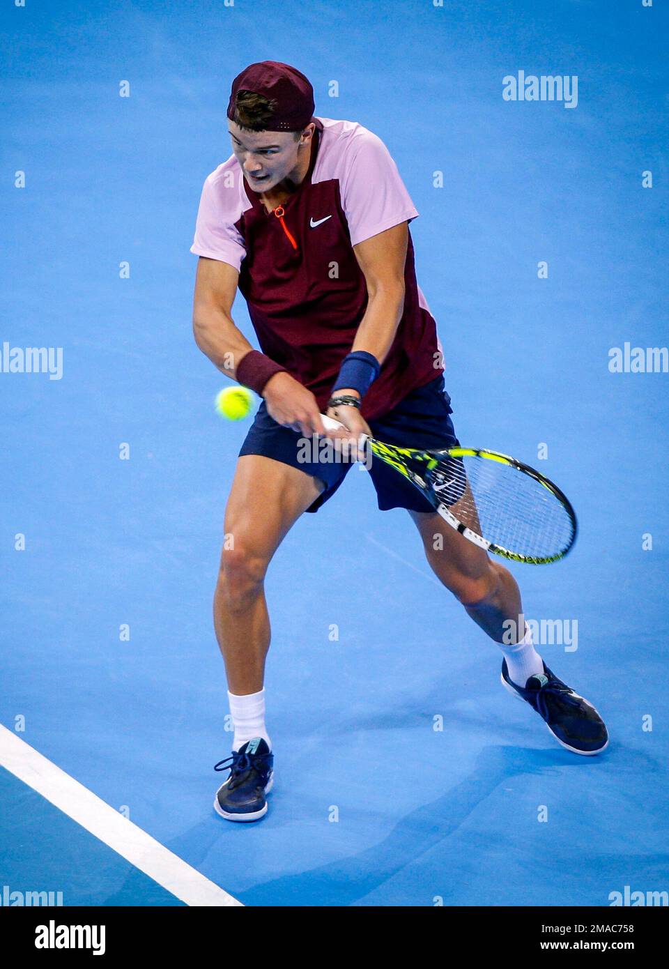 Holger Rune from Denmark returns a shot during his semifinal match against Italy's Jannik Sinner ...