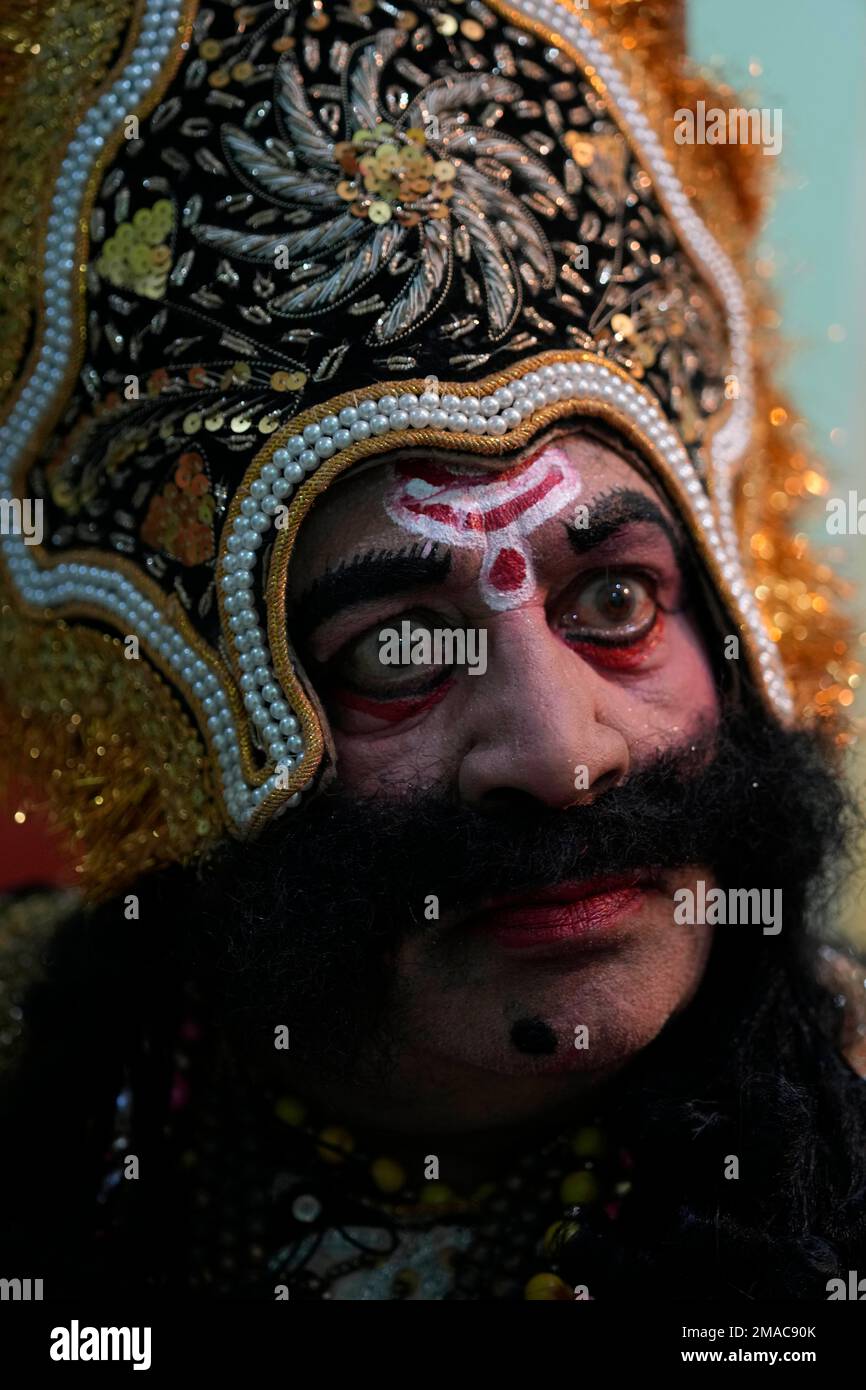 An artist in the role of demon king Ravana performs the traditional ...