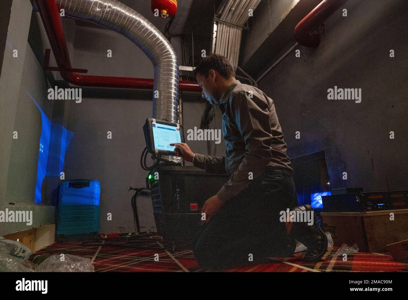 An engineer tests a projector at the newly constructed 'INOX' multiplex ...