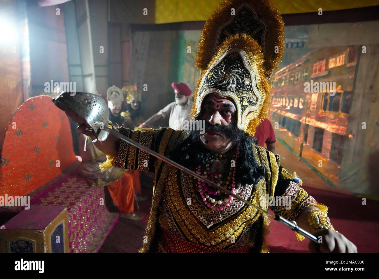 An artist in the role of demon king Ravana rehearses before performing ...