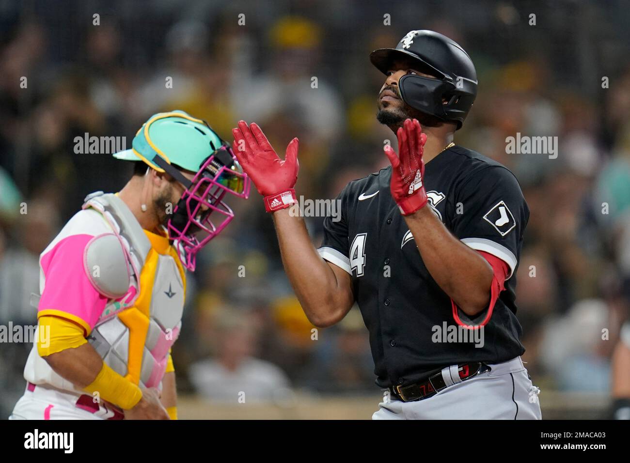 Chicago White Sox's Eloy Jimenez, right, celebrates after hitting a ...