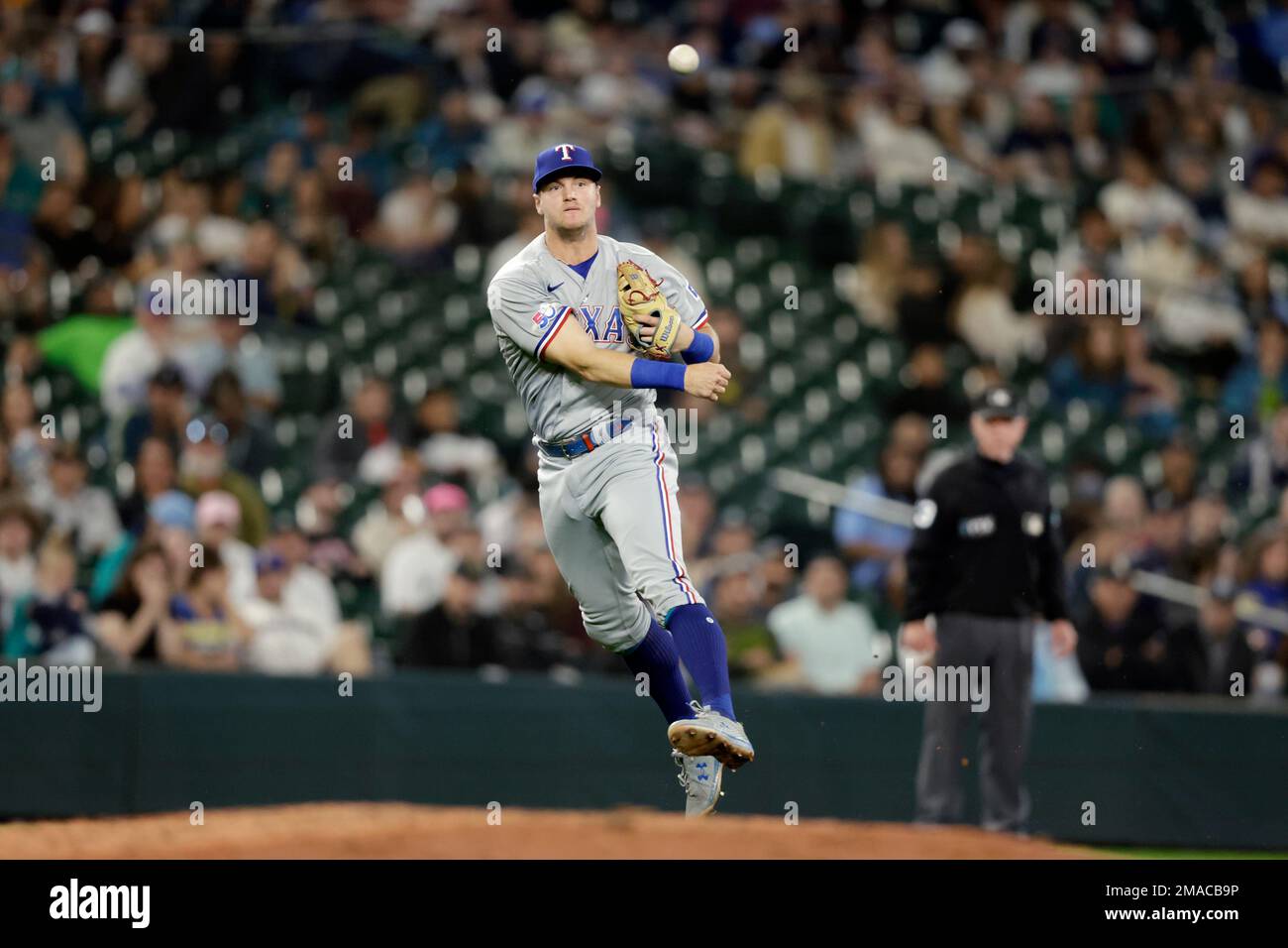 Texas Rangers third baseman Josh Jung throws the ball to first base ...