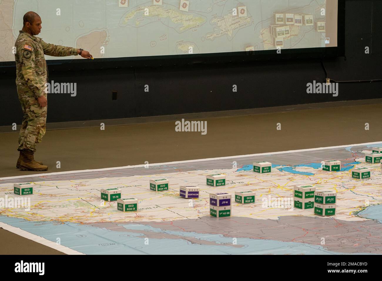 A U.S. Army Soldier uses a laser pointer to direct the audience's ...