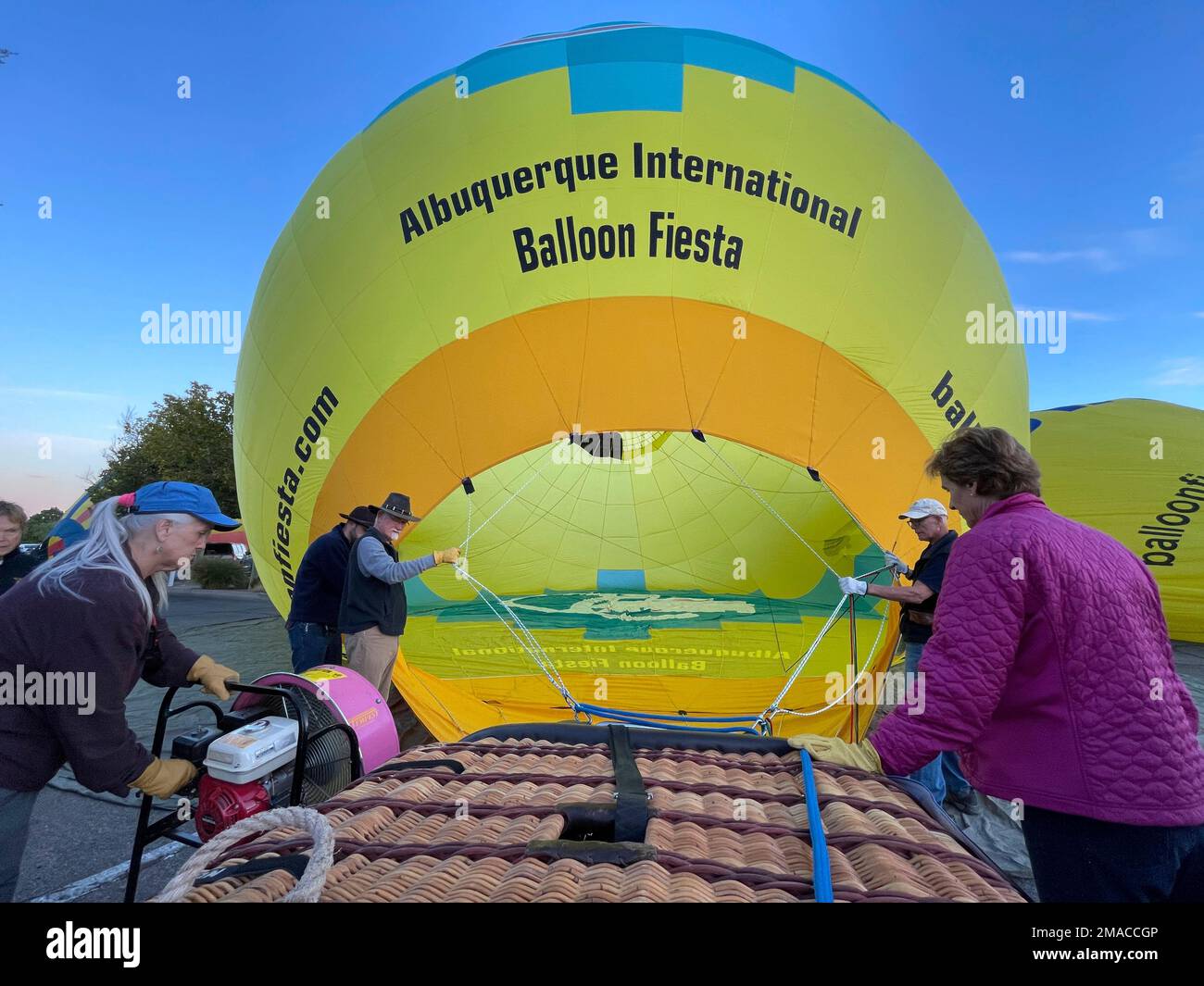 Crew members inflate a hot air balloon as part of a re-enactment of the ...