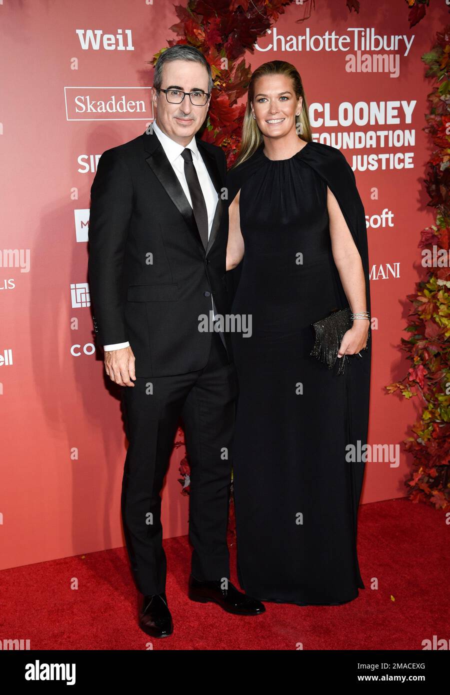 John Oliver, left, and wife Kate Norley attend the Clooney Foundation ...