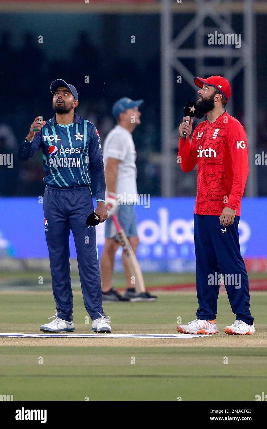 Pakistan's skipper Babar Azam, left, spins the coin as his England's ...