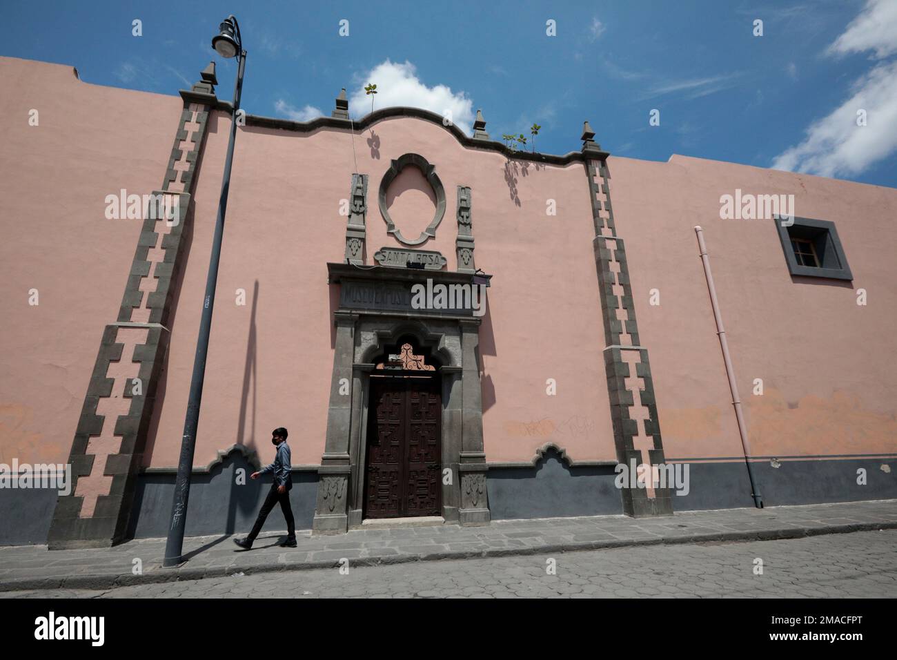 A man walks by the entrance of the former convent of Santa Rosa in ...