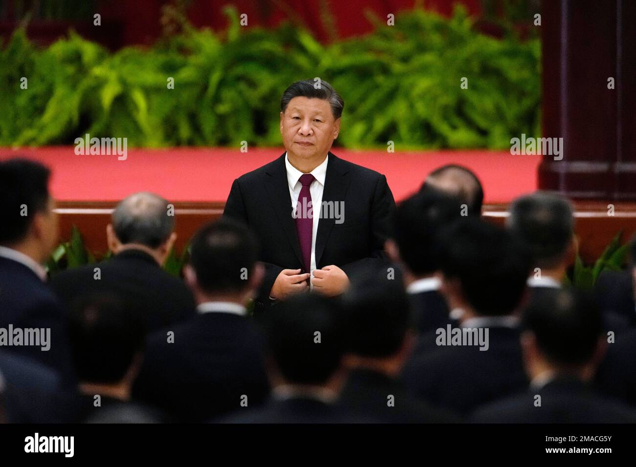Chinese President Xi Jinping adjusts his jacket as he attends a dinner ...