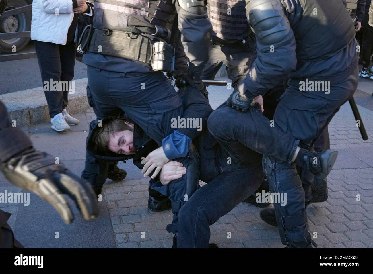 Russian policemen detain a demonstrator protesting against mobilization ...