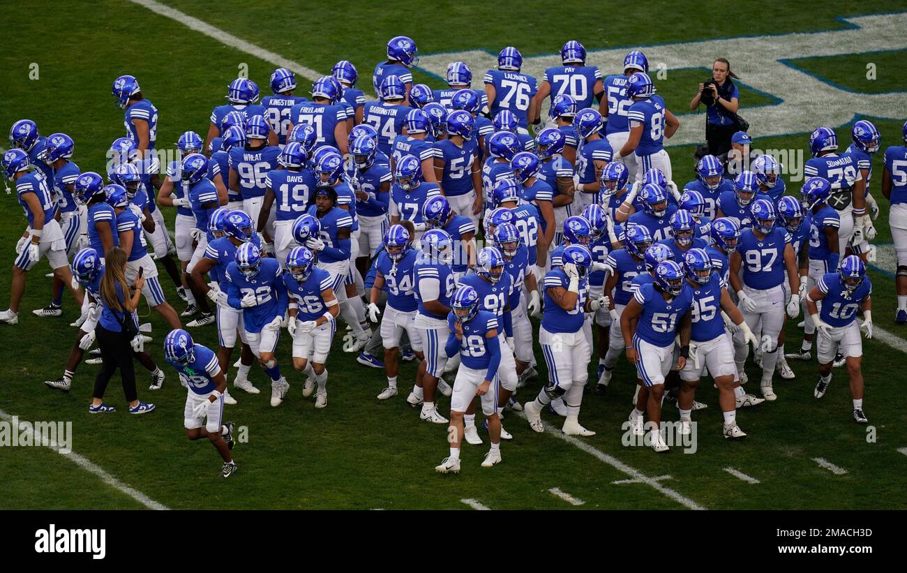 The BYU team breaks a huddle before an NCAA college football game ...