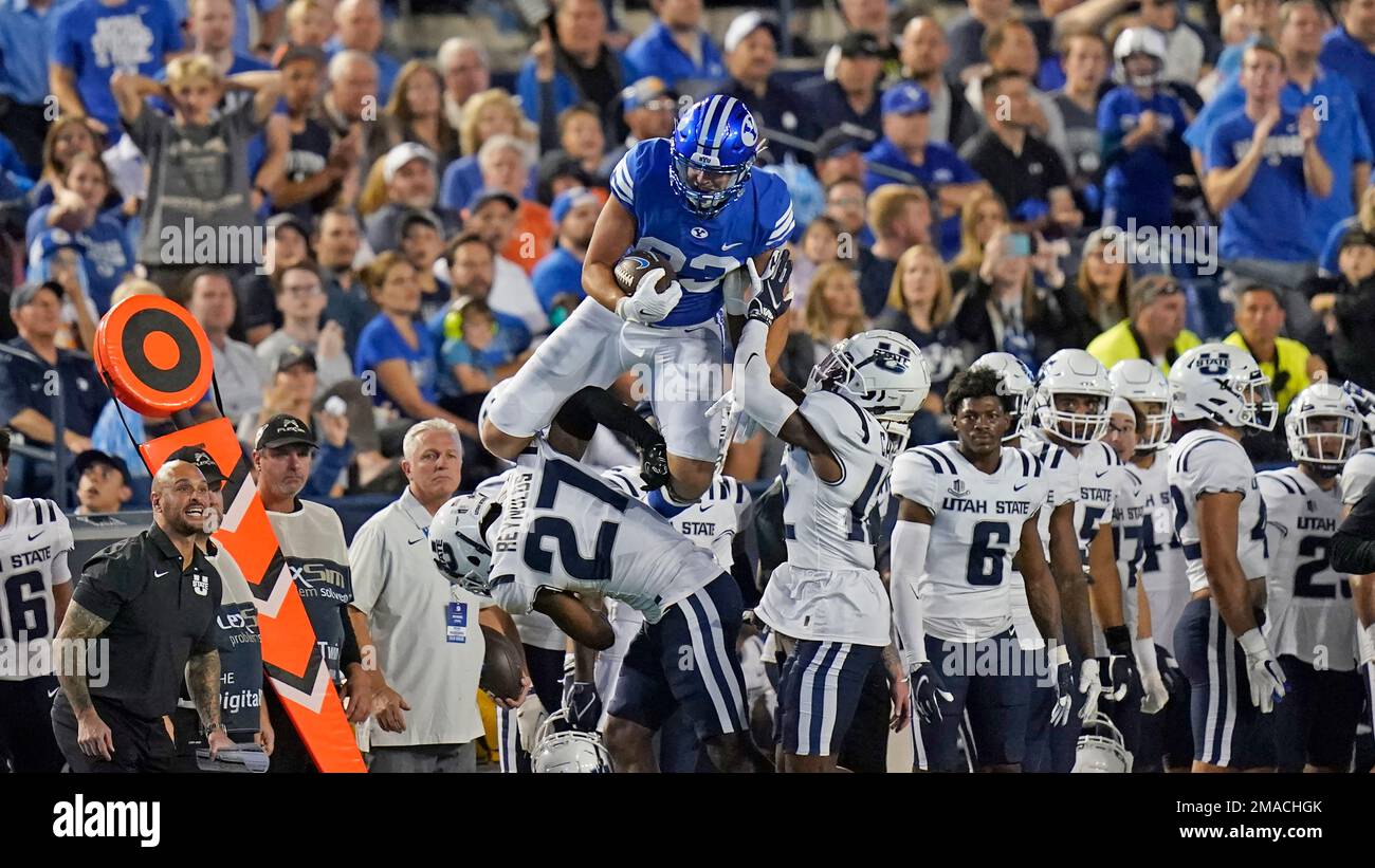 BYU tight end Isaac Rex (83) leaps over Utah State safety Hunter ...