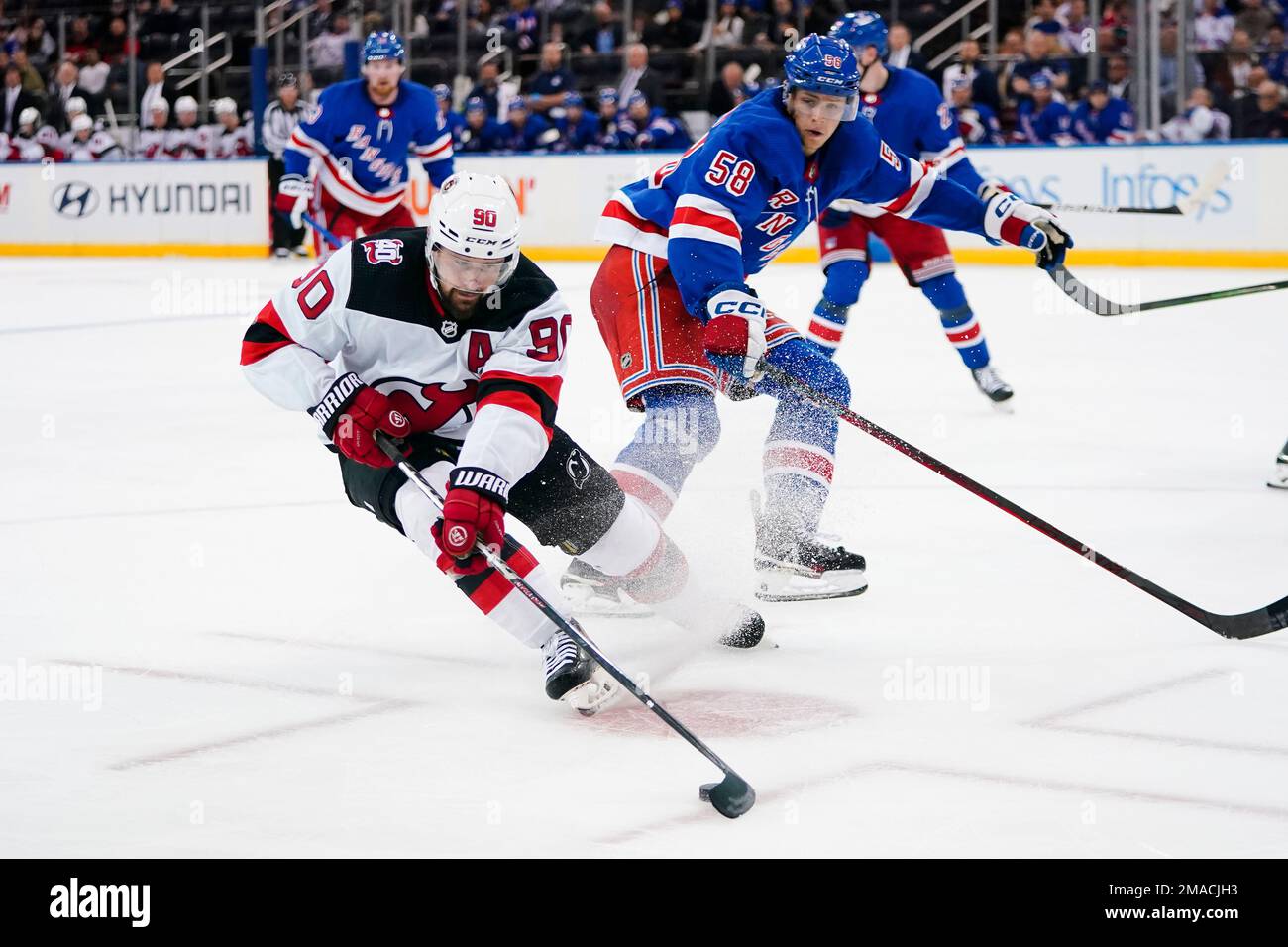 New Jersey Devils' Tomas Tatar (90) vies for control of the puck ...