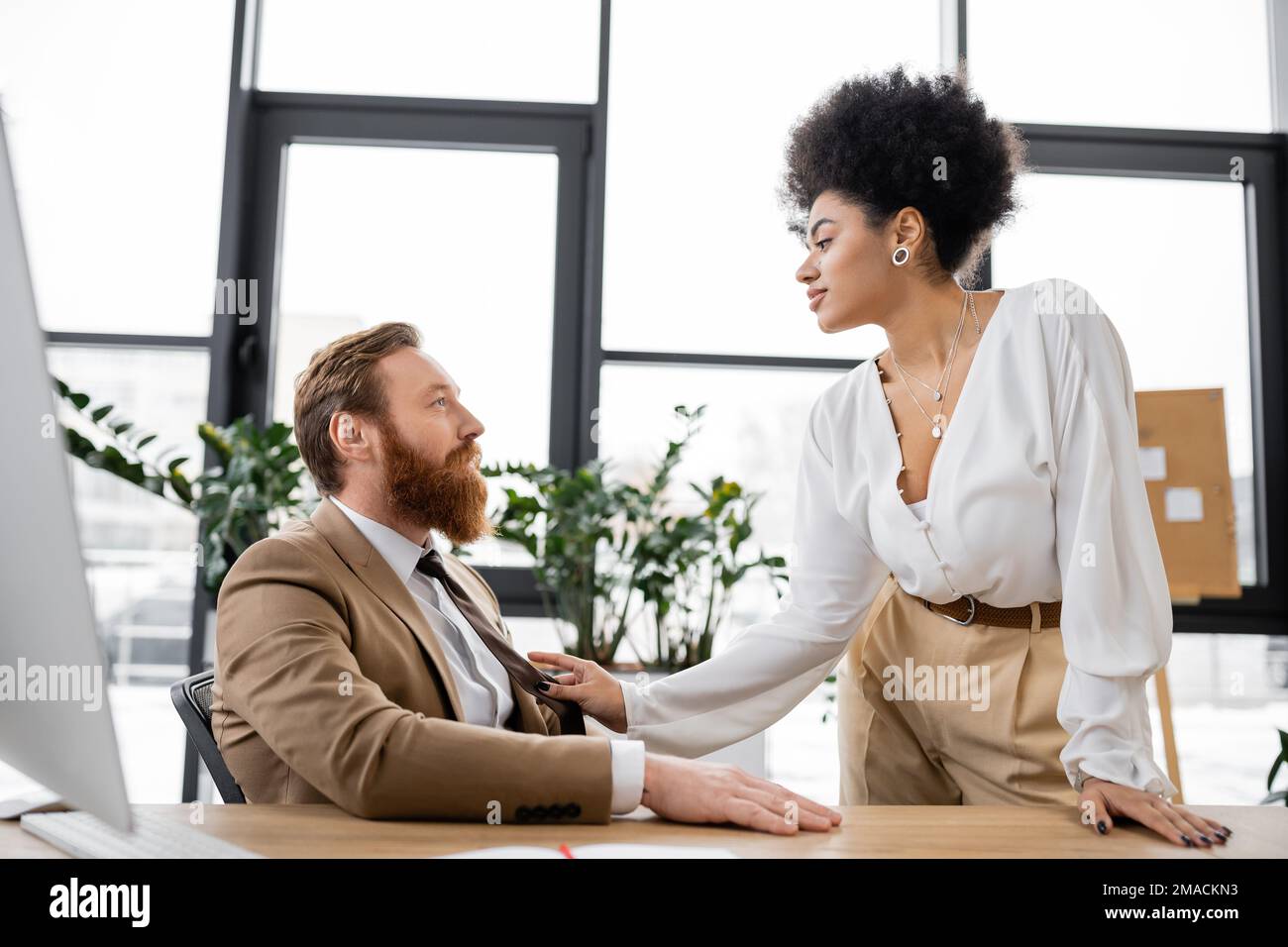 Side View Of Sensual African American Woman Pulling Tie While Seducing