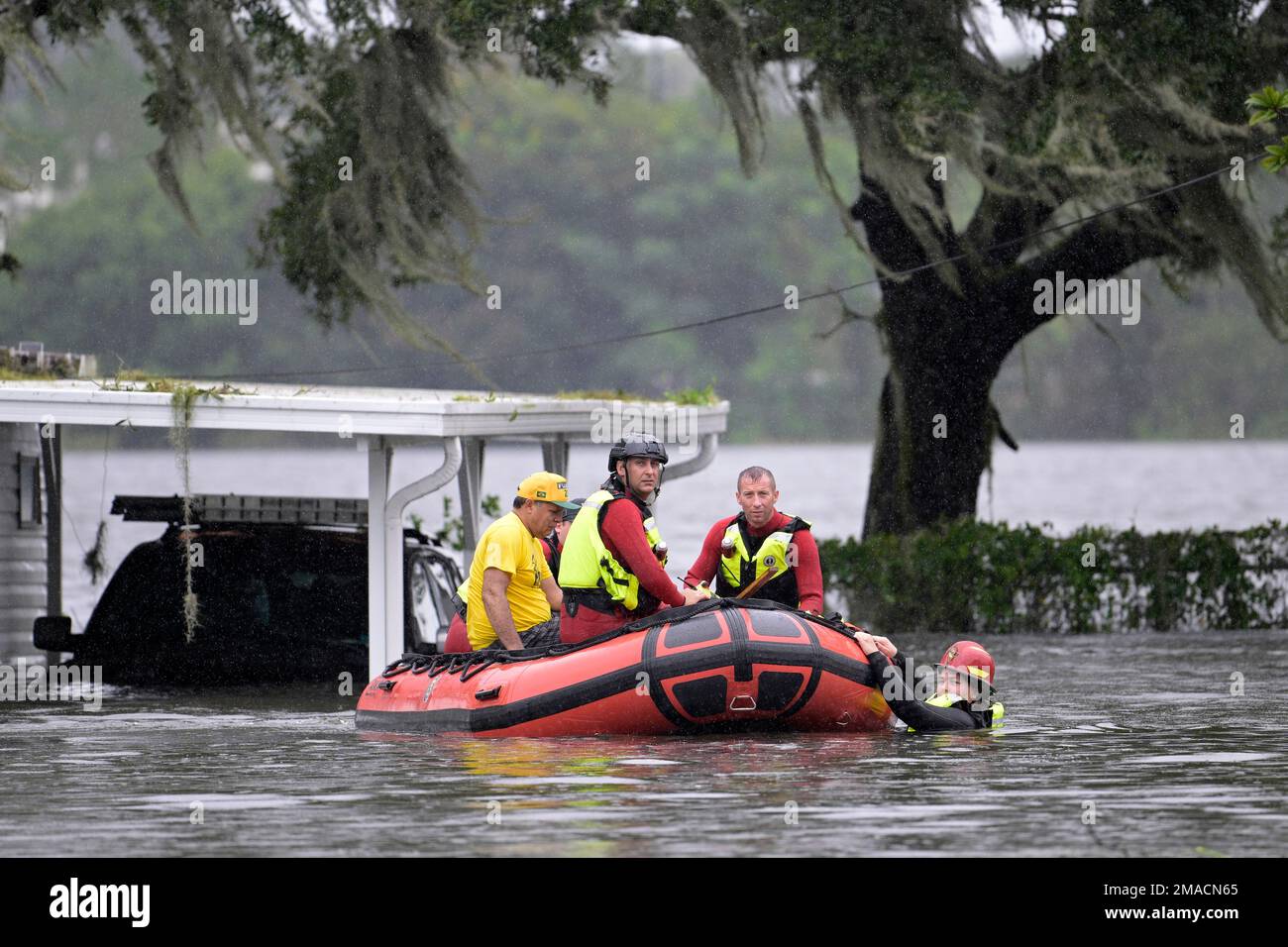 First responders with Orange County Fire Rescue use an inflatable boat ...