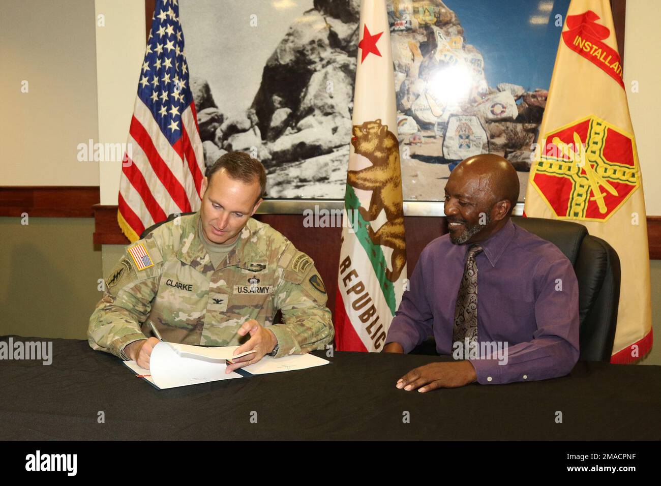 Col. Jason Clarke (left), the Fort Irwin garrison commander, signs an ...