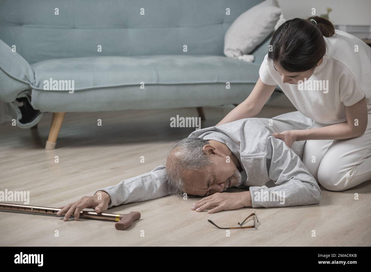 Asia young woman halping her father after falling down on floor Stock ...