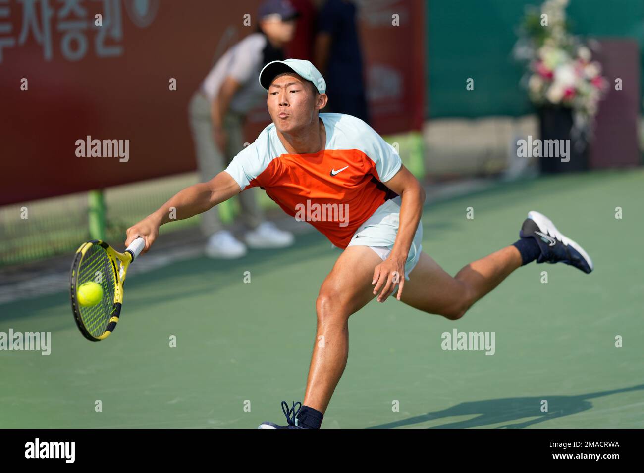 Tseng Chun-hsin of Taiwan returns a shot to Aleksandar Kovacevic of the ...
