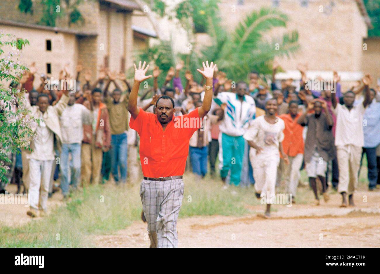 FILE - Rwandan refugees hold their hands up and ask for help from ...