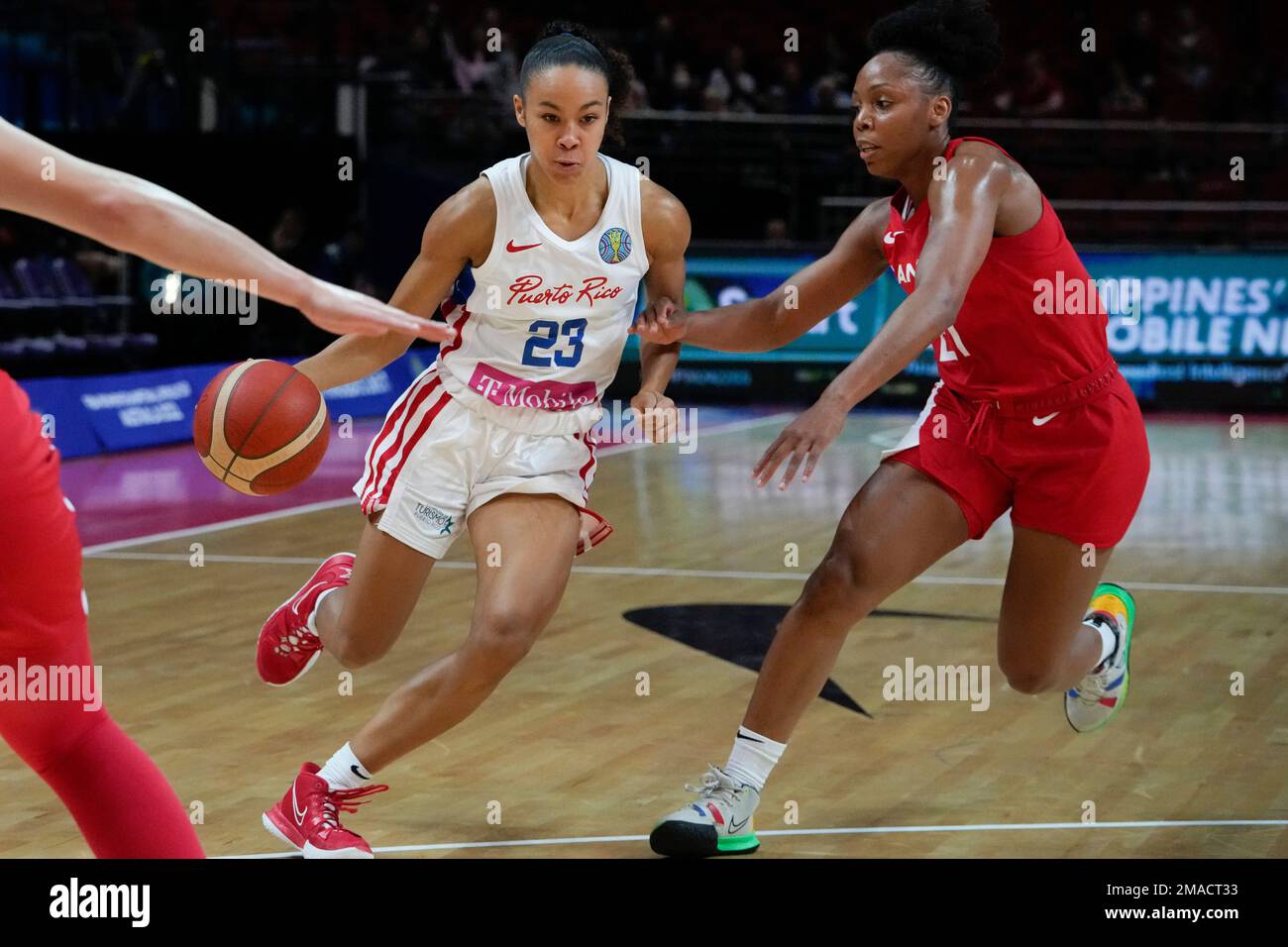 Puerto Rico's Trinity San Antonio runs past Canada's Nirra Fields, right, during their ...