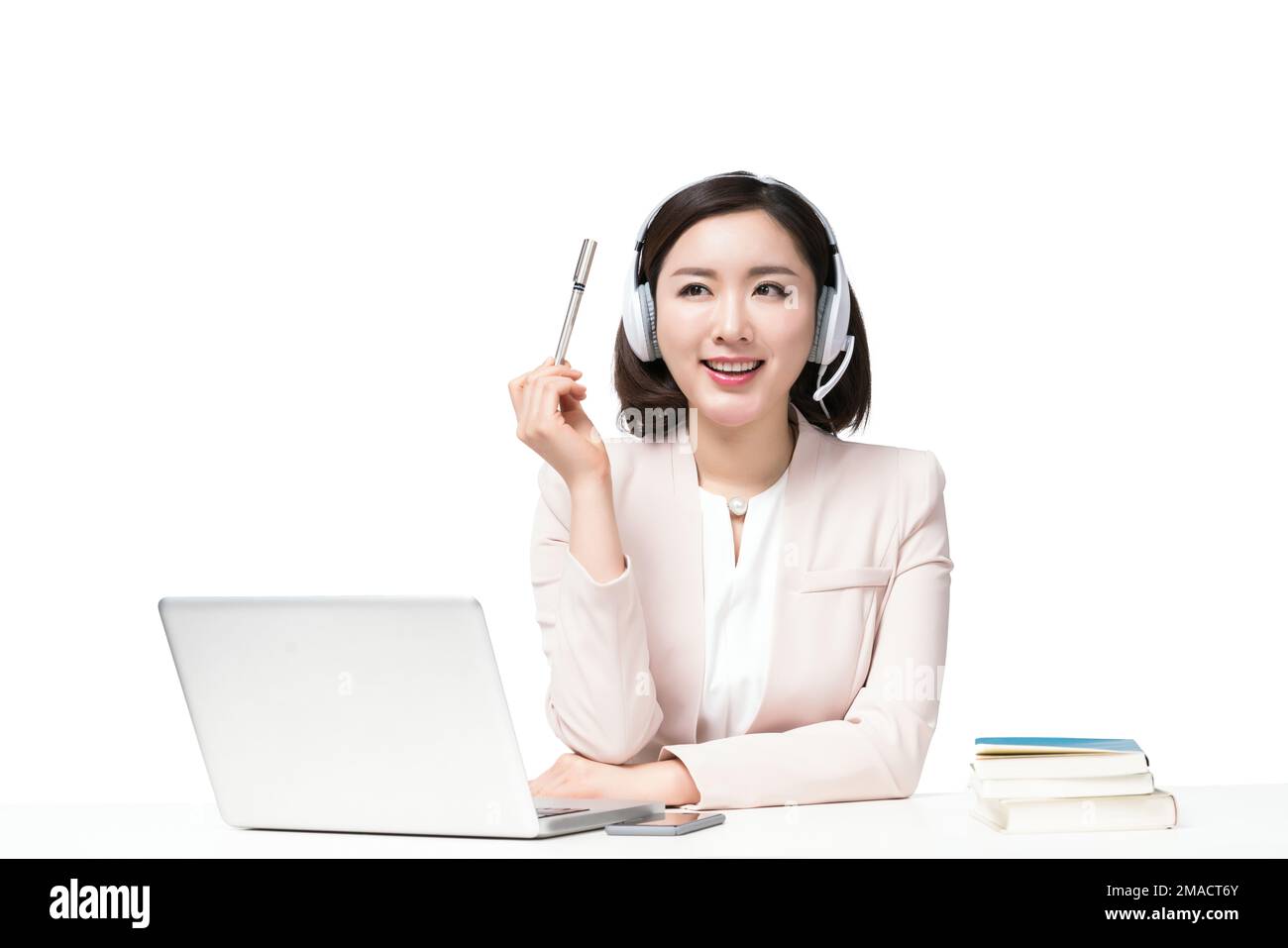 Young woman wearing a headset to use a computer Stock Photo - Alamy