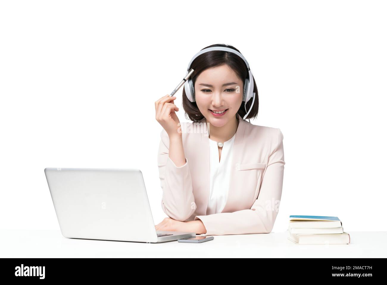 Young woman wearing a headset to use a computer Stock Photo - Alamy