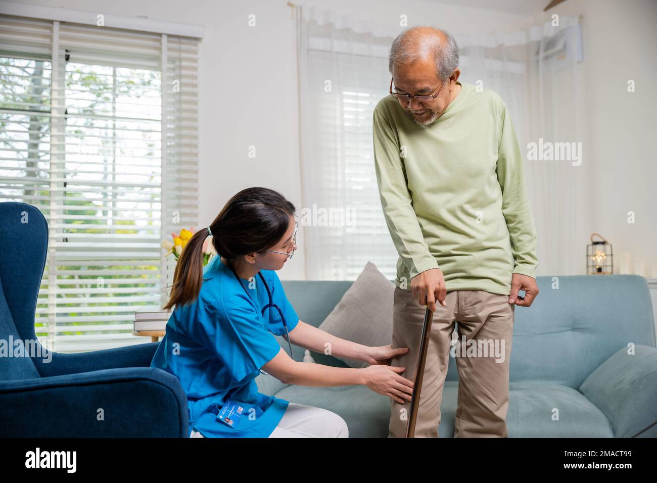 nurse checking knee and leg after surgery of senior old man patient ...