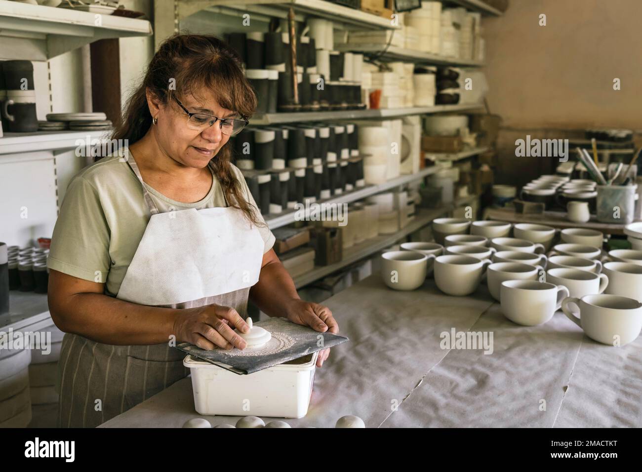 Ceramist working in pottery studio. Ceramists hands dirty clay. Process ...