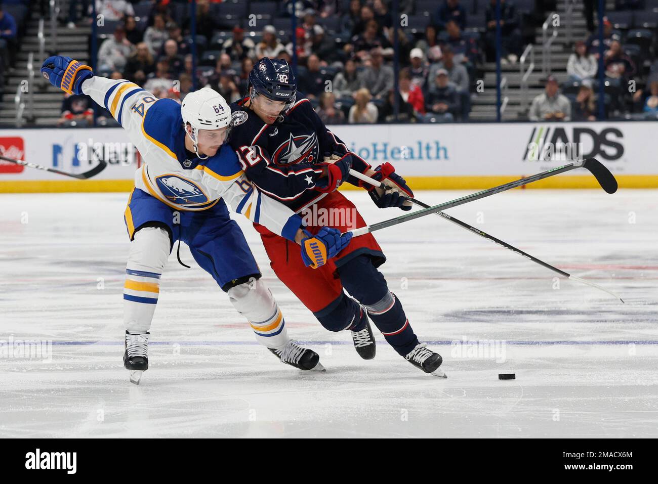Columbus Blue Jackets' Mikael Pyyhtia, right, carries the puck up ice ...