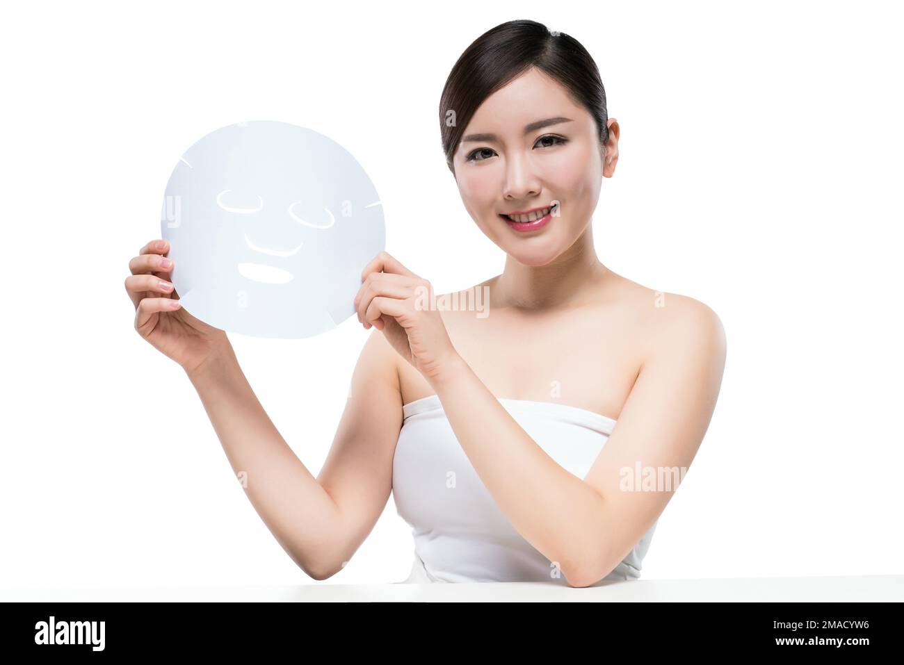 A beautiful young woman holding a mask Stock Photo - Alamy