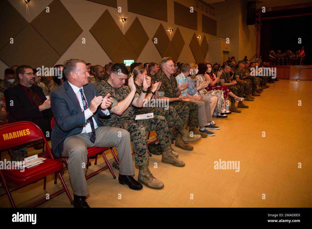 Attendees applaud during a change of command ceremony at the community ...