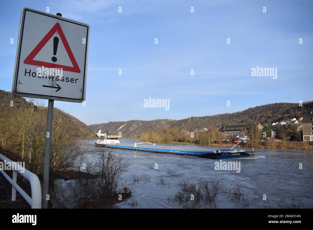 cargo ship next to a flood warning sign Stock Photo - Alamy