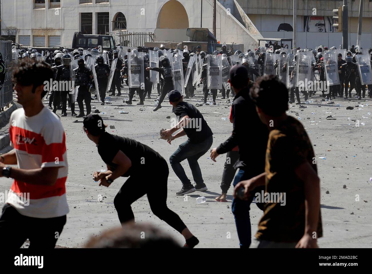 Anti-government protesters throw stones towards security forces during ...