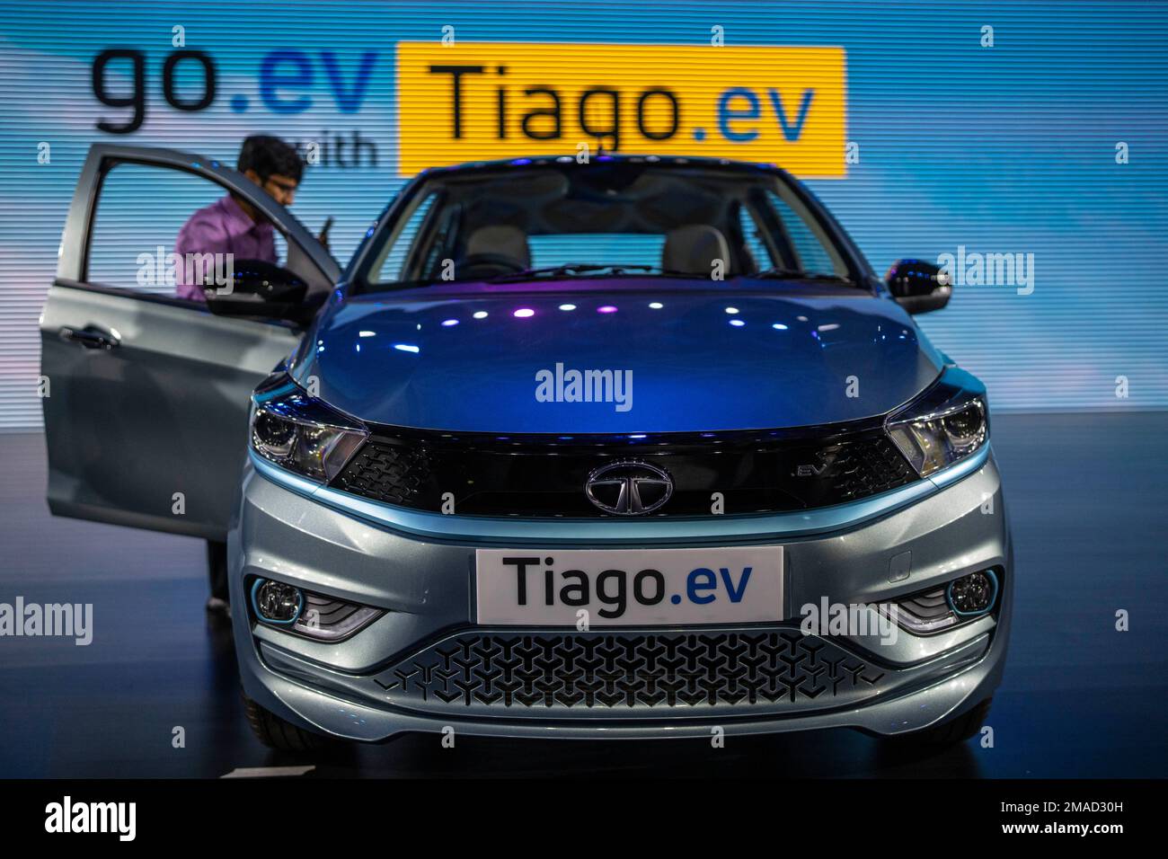 A journalist takes picture of Tata Tiago EV electric car during its global launch in Mumbai ...