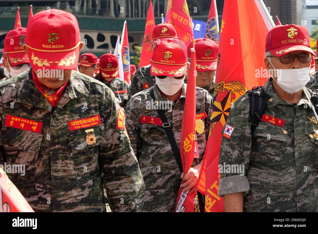 Marine veterans observe a moment of silence during the ceremony of the ...