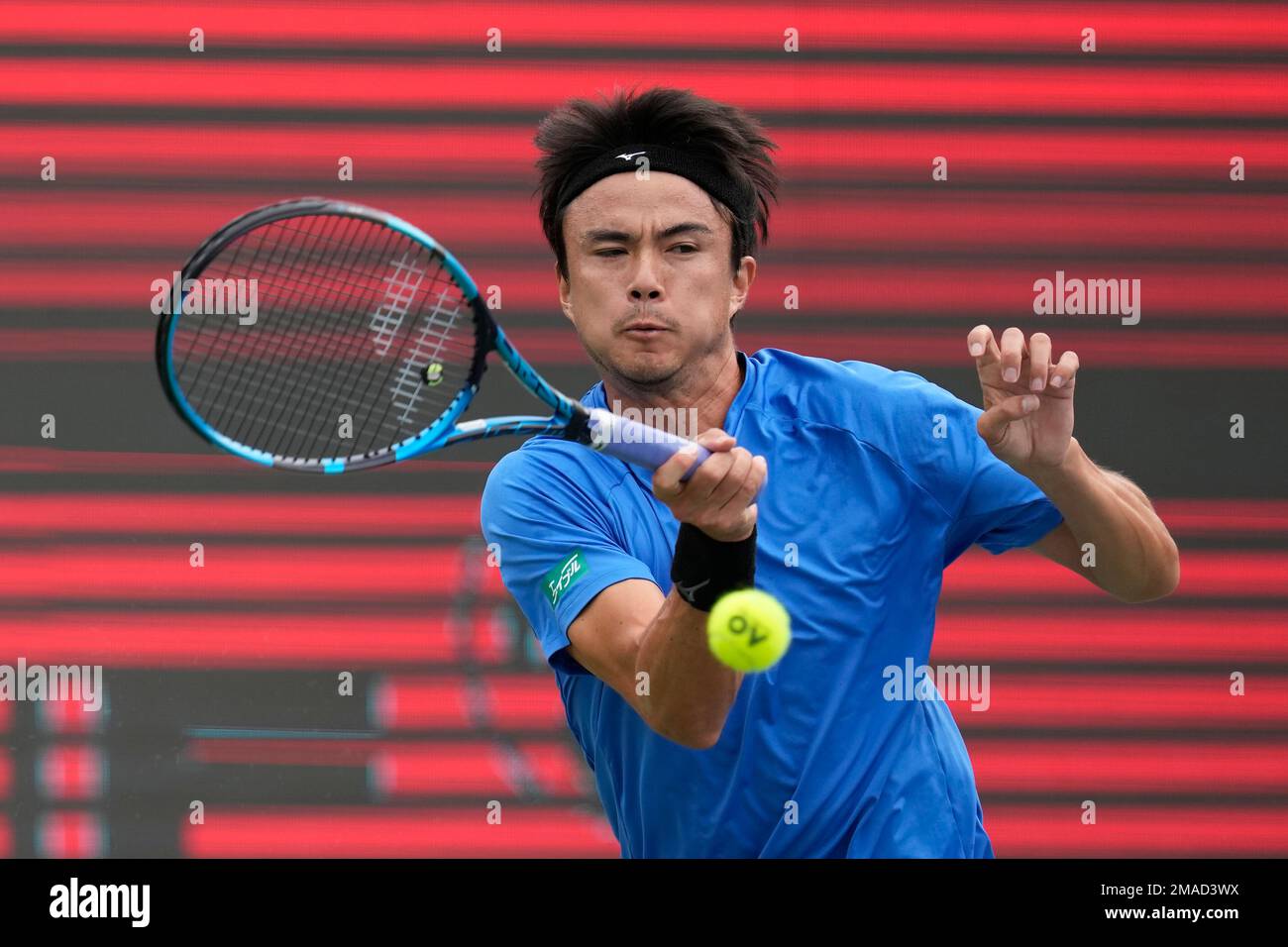 Japan's Taro Daniel returns a shot to Ecuador's Emilio Gomez during the ...