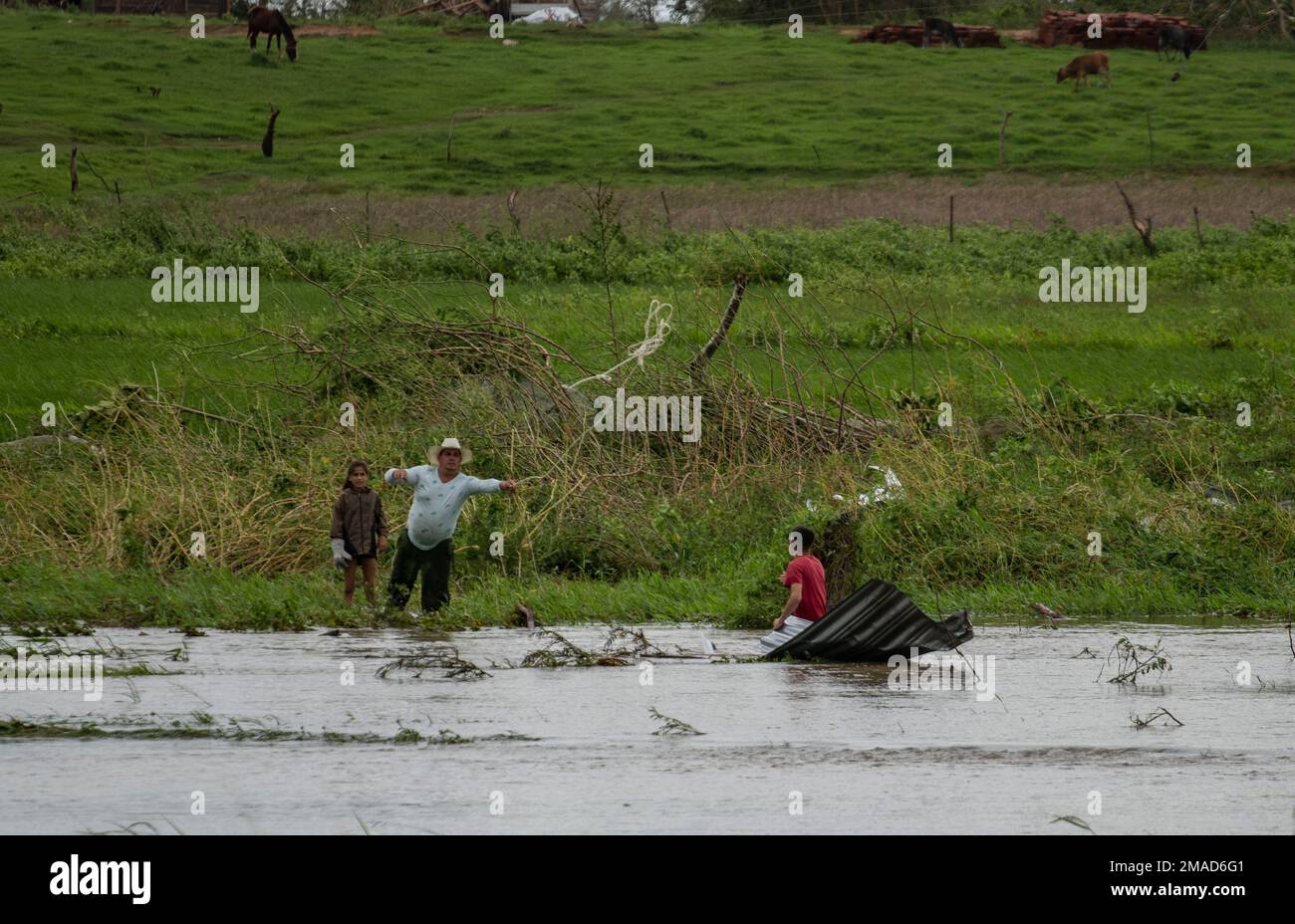 A man recovers pieces of roofing smashed by Hurricane Ian in Pinar del ...