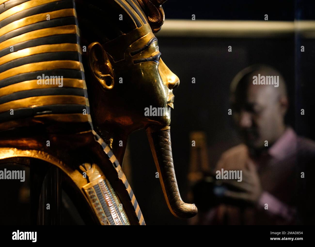 A man films the golden mask of King Tutankhamun at the Egyptian Museum ...