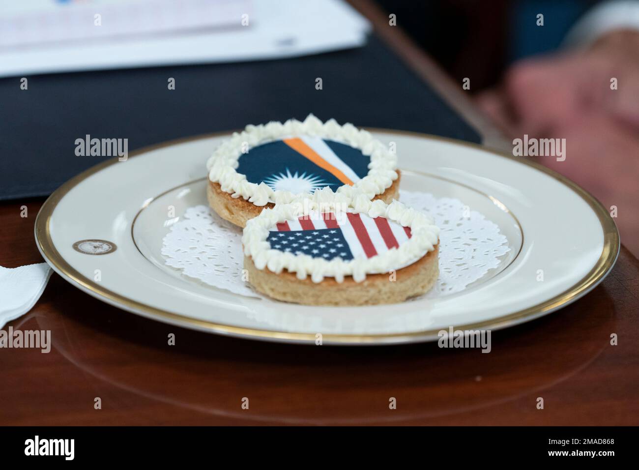 The countries' flags are seen on cookies during a meeting with Marshall ...