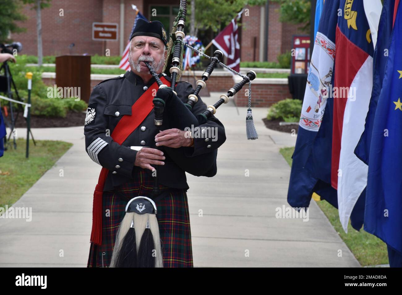 A bagpiper pipes the hymn "Amazing Grace" during the final moments of ...