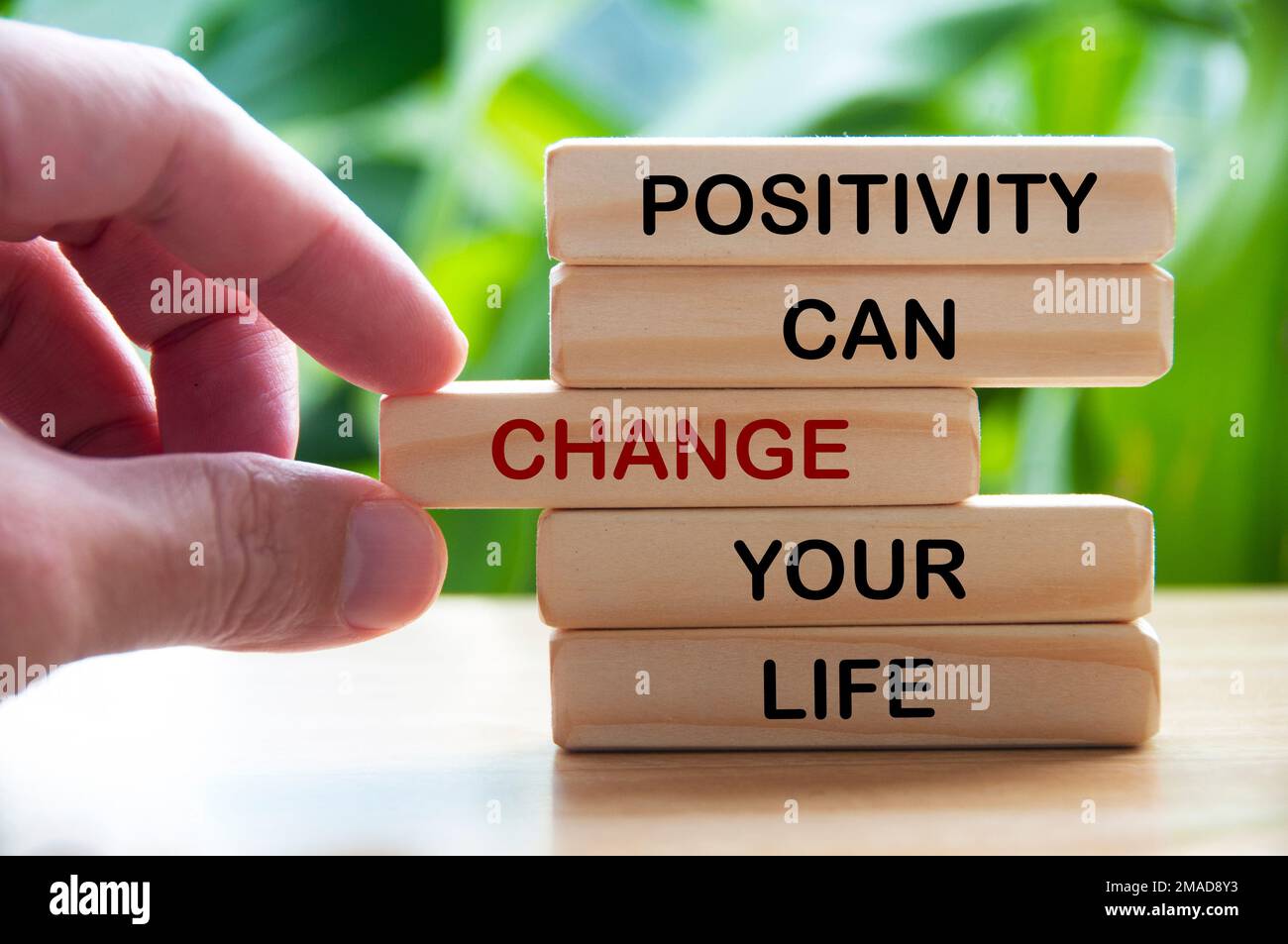 Positivity can change your life text on wooden blocks with hand and ...