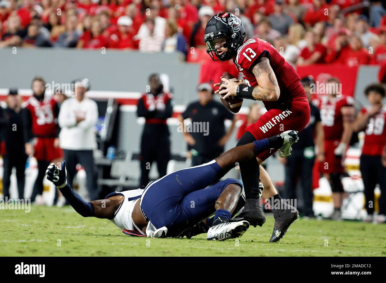 North Carolina State's Devin Leary (13) avoids a sack against ...