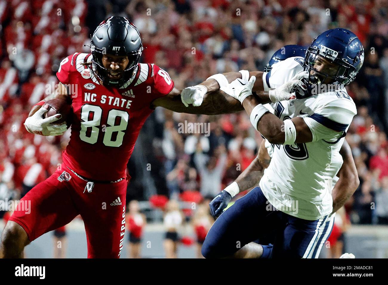 North Carolina State's Devin Carter (88) stiff arms Connecticut's Cale ...
