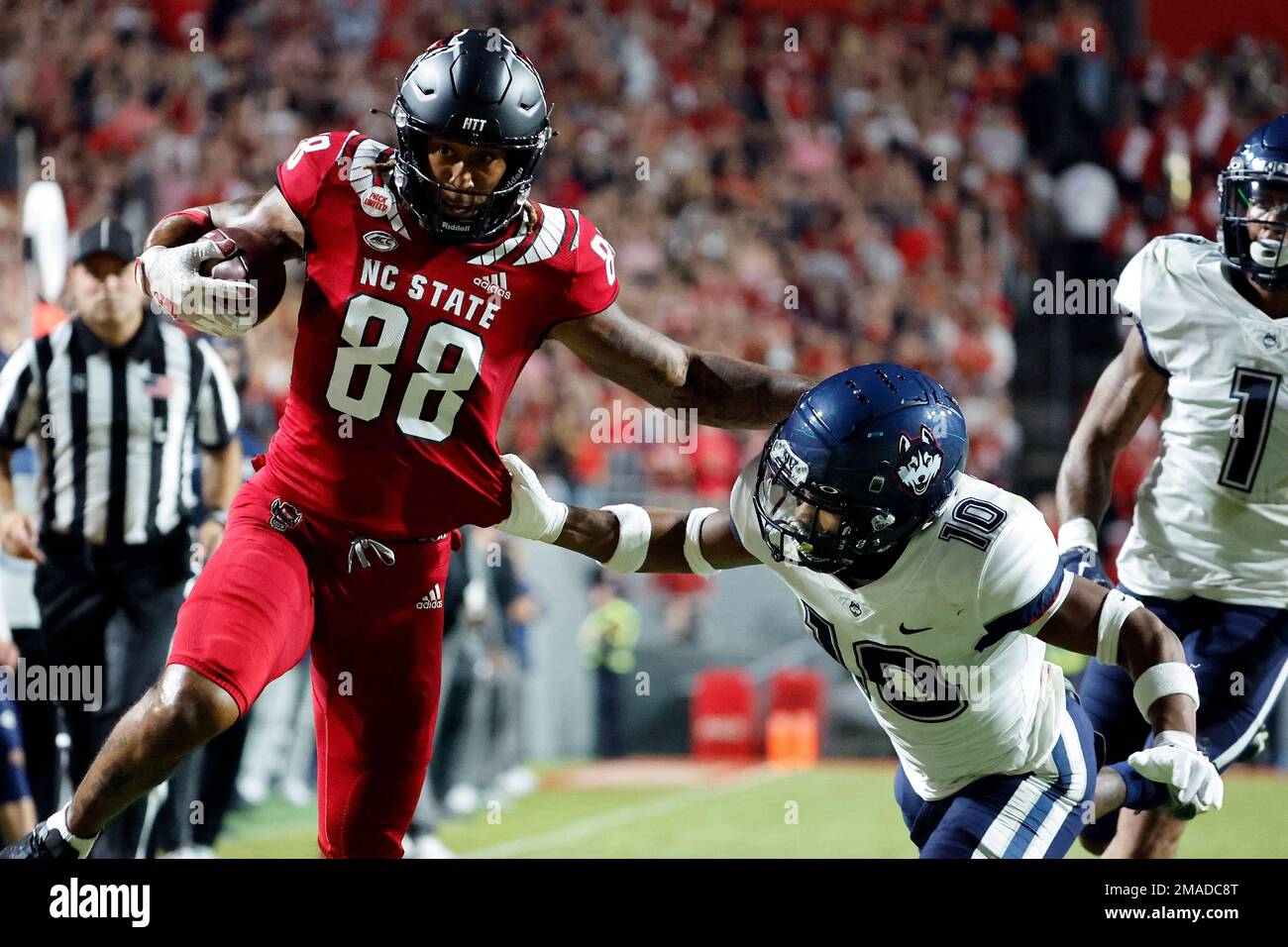 North Carolina State's Devin Carter (88) stiff arms Connecticut's Cale ...